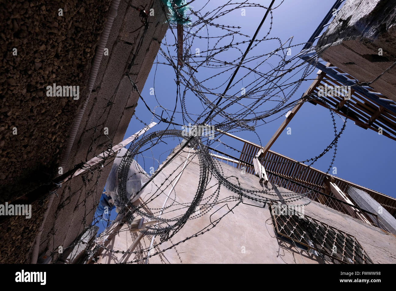 Barbed wire fence surrounding a building that Jewish settlers acquired ...