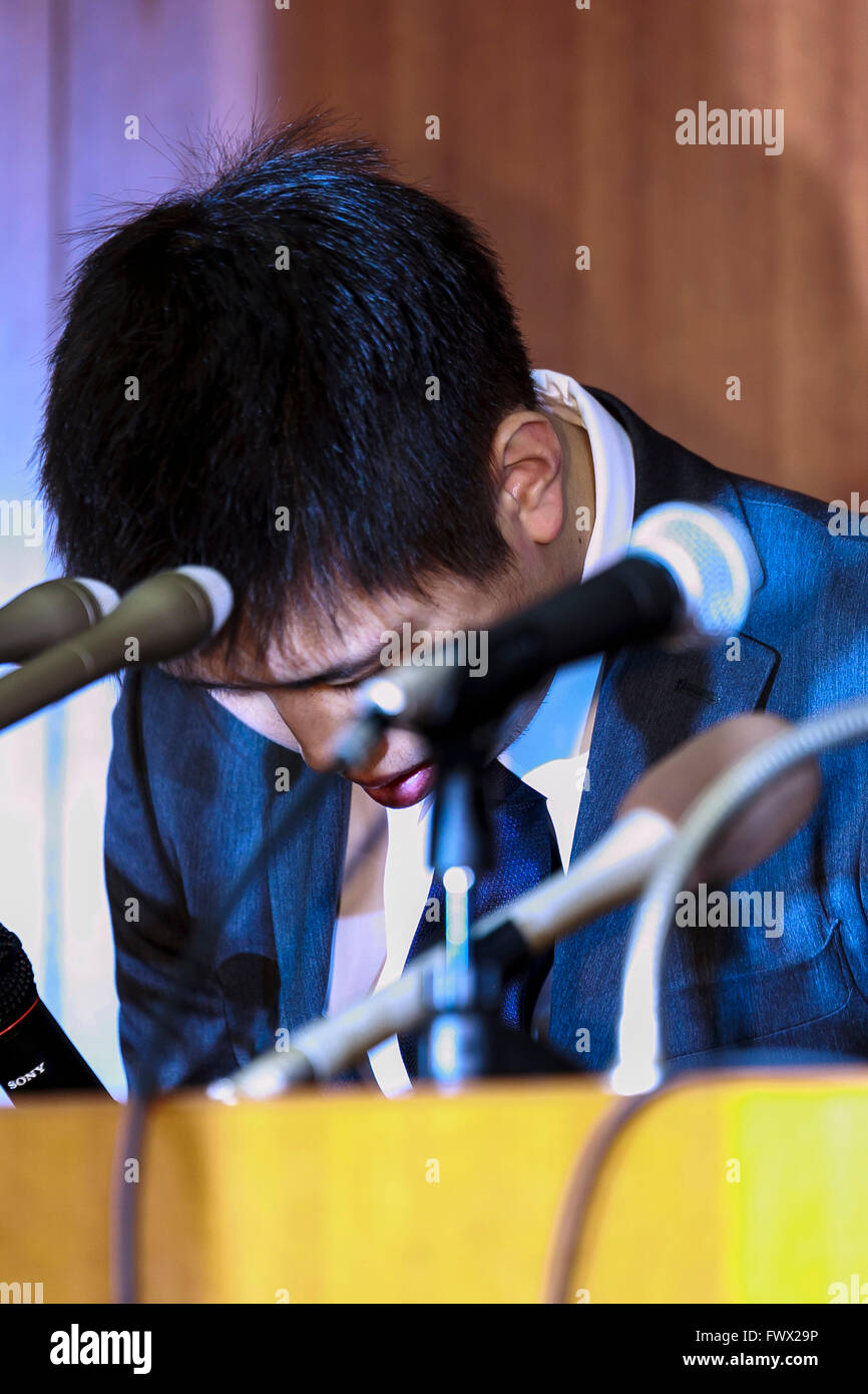 Japanese badminton player Kenichi Tago bows in deep apology during a ...