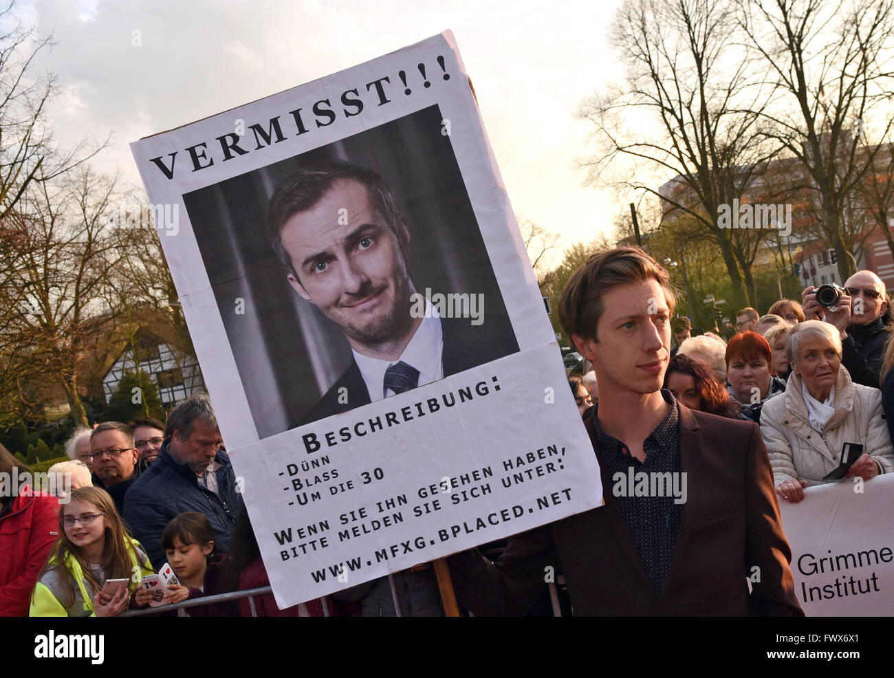 Actor Max Mauff holds up a poster written with 'missing' referring to ...