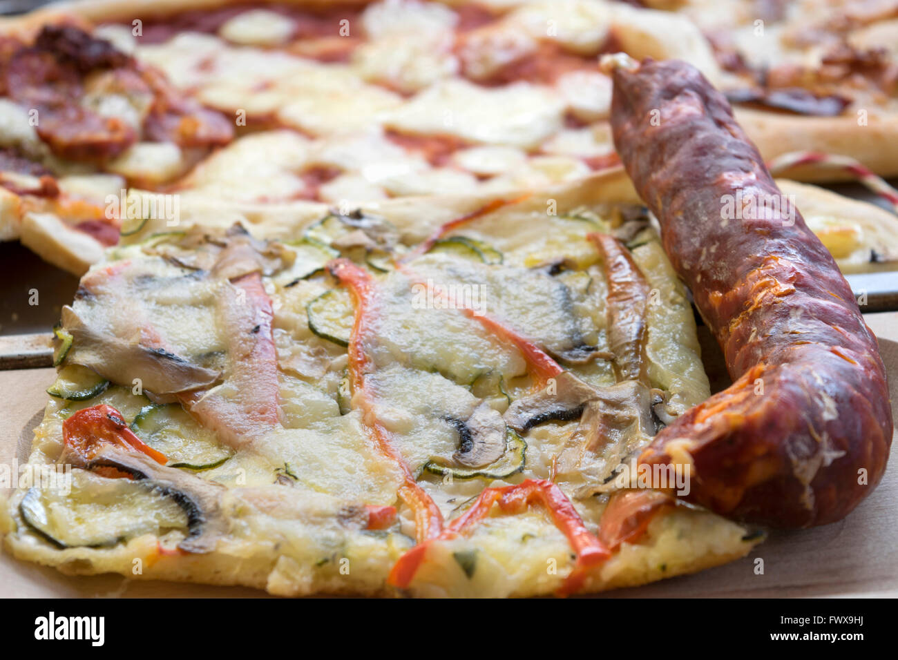 wedge pizza with thin spicy salami and zucchini and mozzarella Stock ...