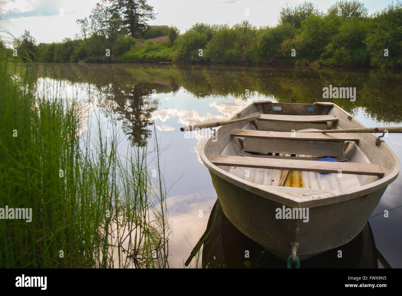 A rowing boat by the calm river, Pulkkila Finland Stock Photo - Alamy