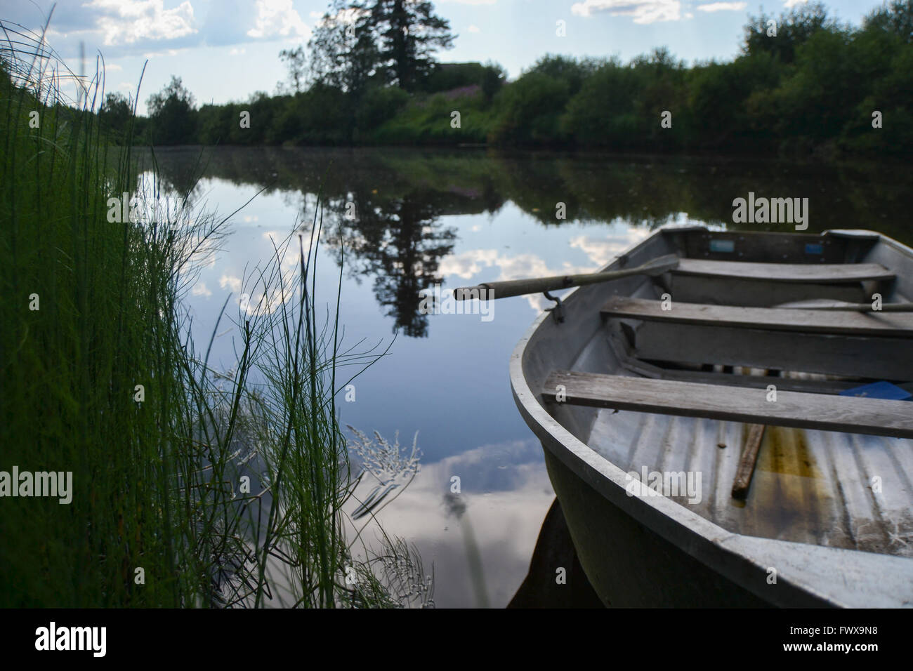 A rowing boat by the calm river, Pulkkila Finland Stock Photo - Alamy
