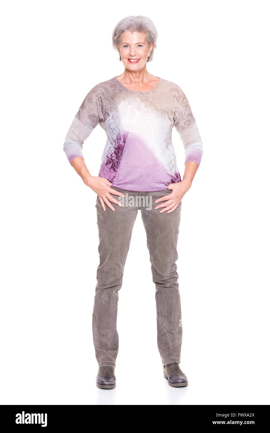 Active senior woman standing in front of white background Stock Photo ...