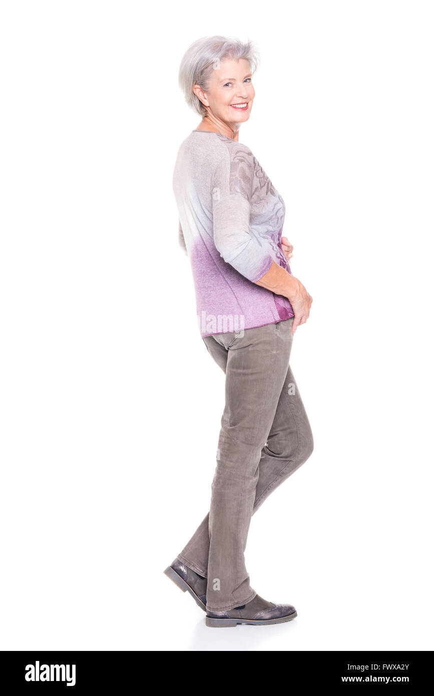 Active senior woman standing in front of white background Stock Photo ...