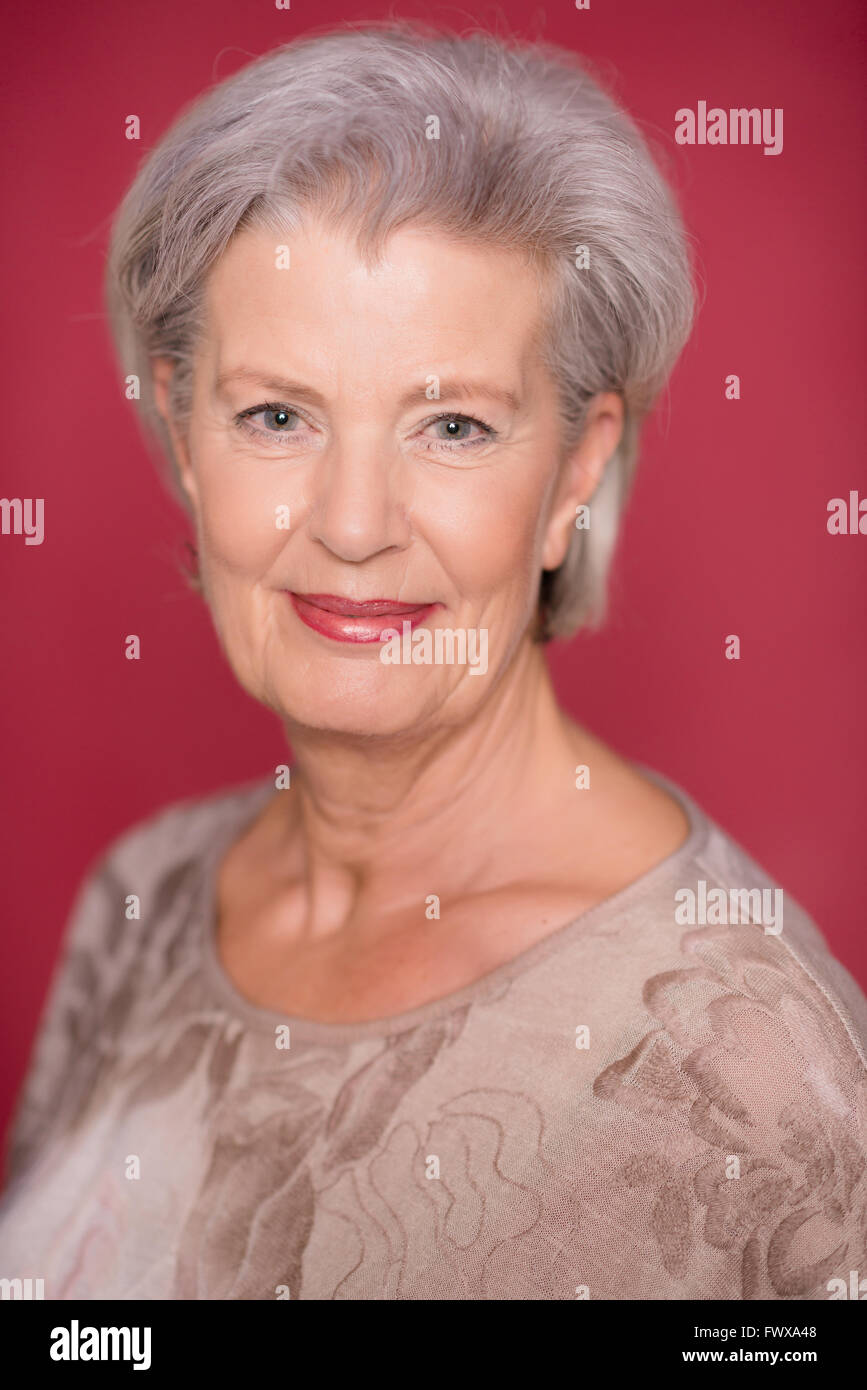 Happy seior woman in front of red background Stock Photo - Alamy