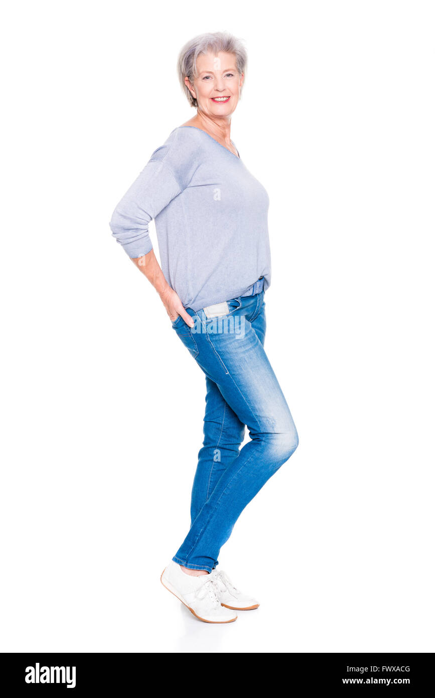 Senior woman standing in front of white background Stock Photo - Alamy