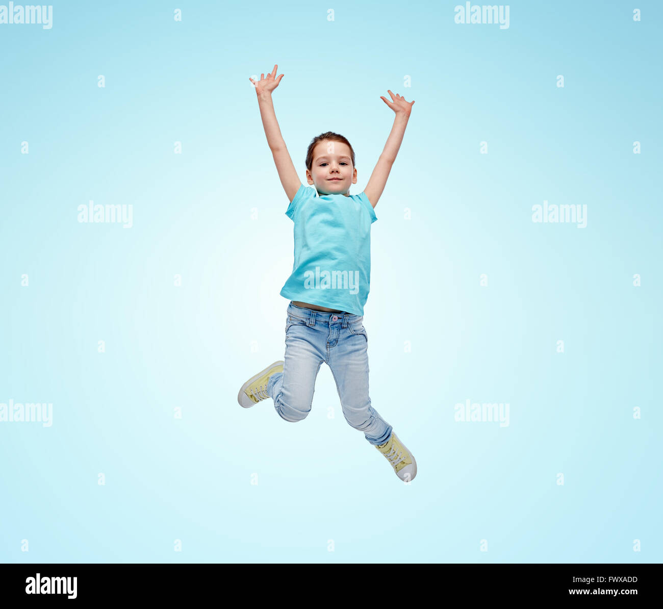 happy little girl jumping in air over blue Stock Photo - Alamy