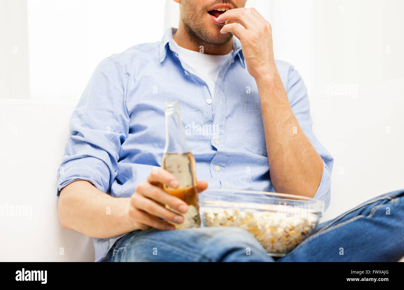 close up of man with popcorn and beer at home Stock Photo - Alamy