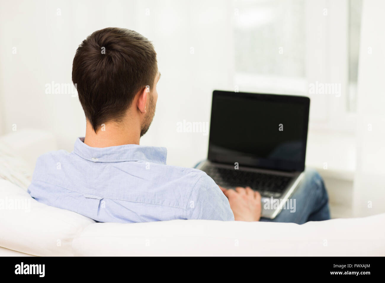 Man on computer home rear view hi-res stock photography and images - Alamy