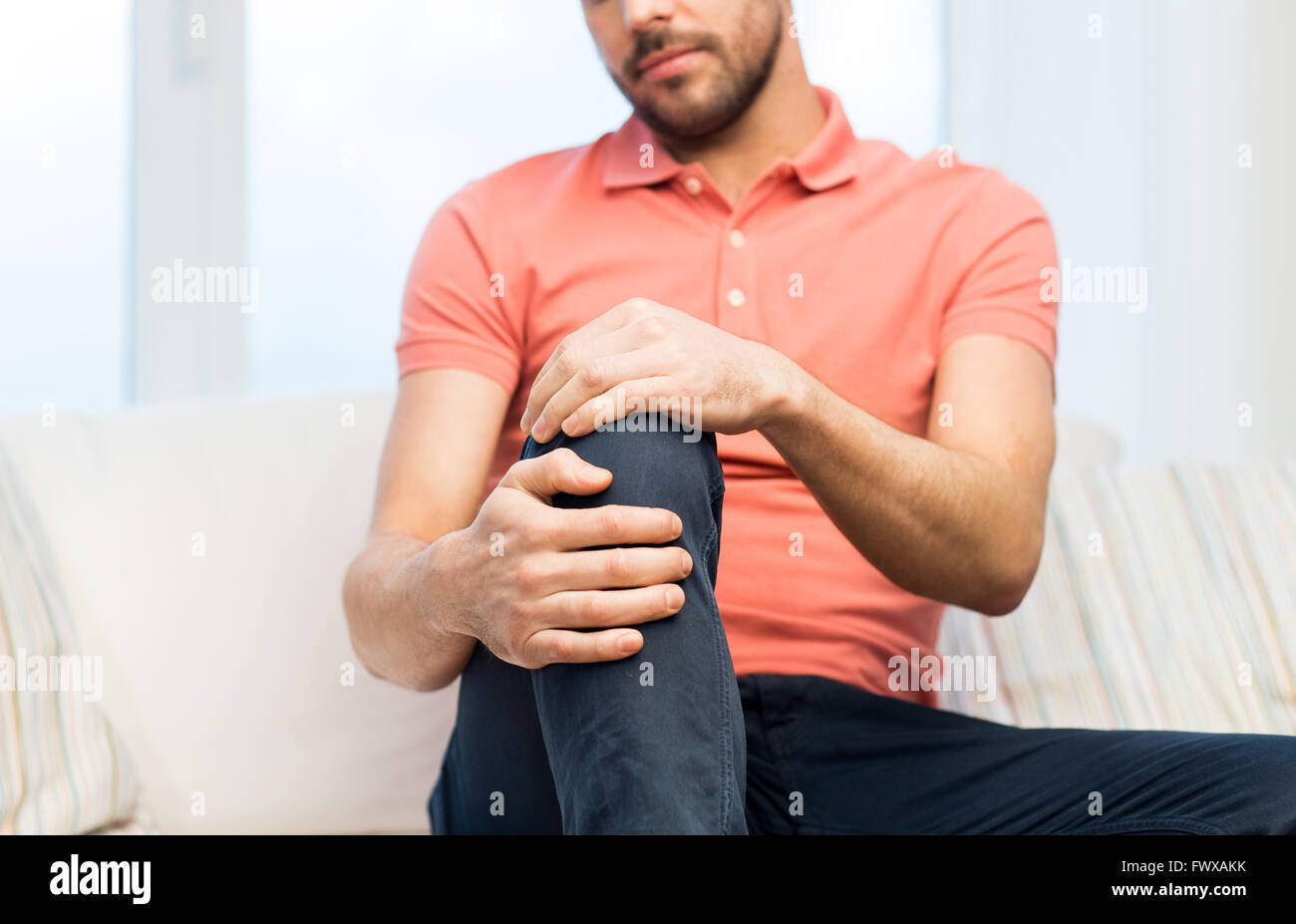 close up of man suffering from pain in leg at home Stock Photo - Alamy