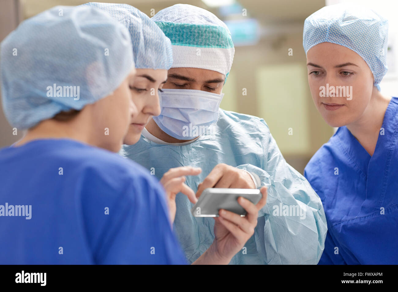 group of surgeons with smartphone at hospital Stock Photo - Alamy