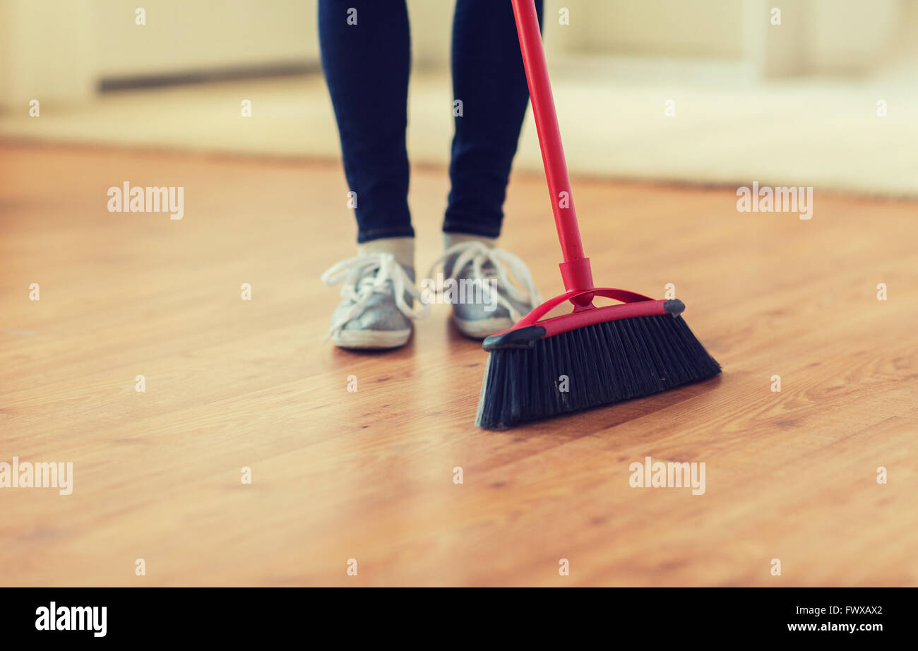 close up of woman legs with broom sweeping floor Stock Photo - Alamy