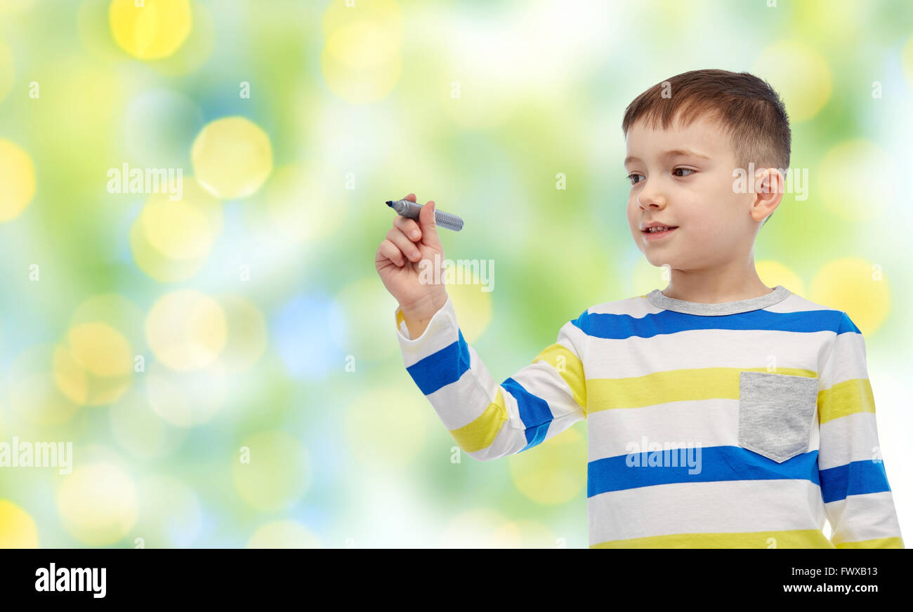 little boy drawing or writing with marker Stock Photo - Alamy