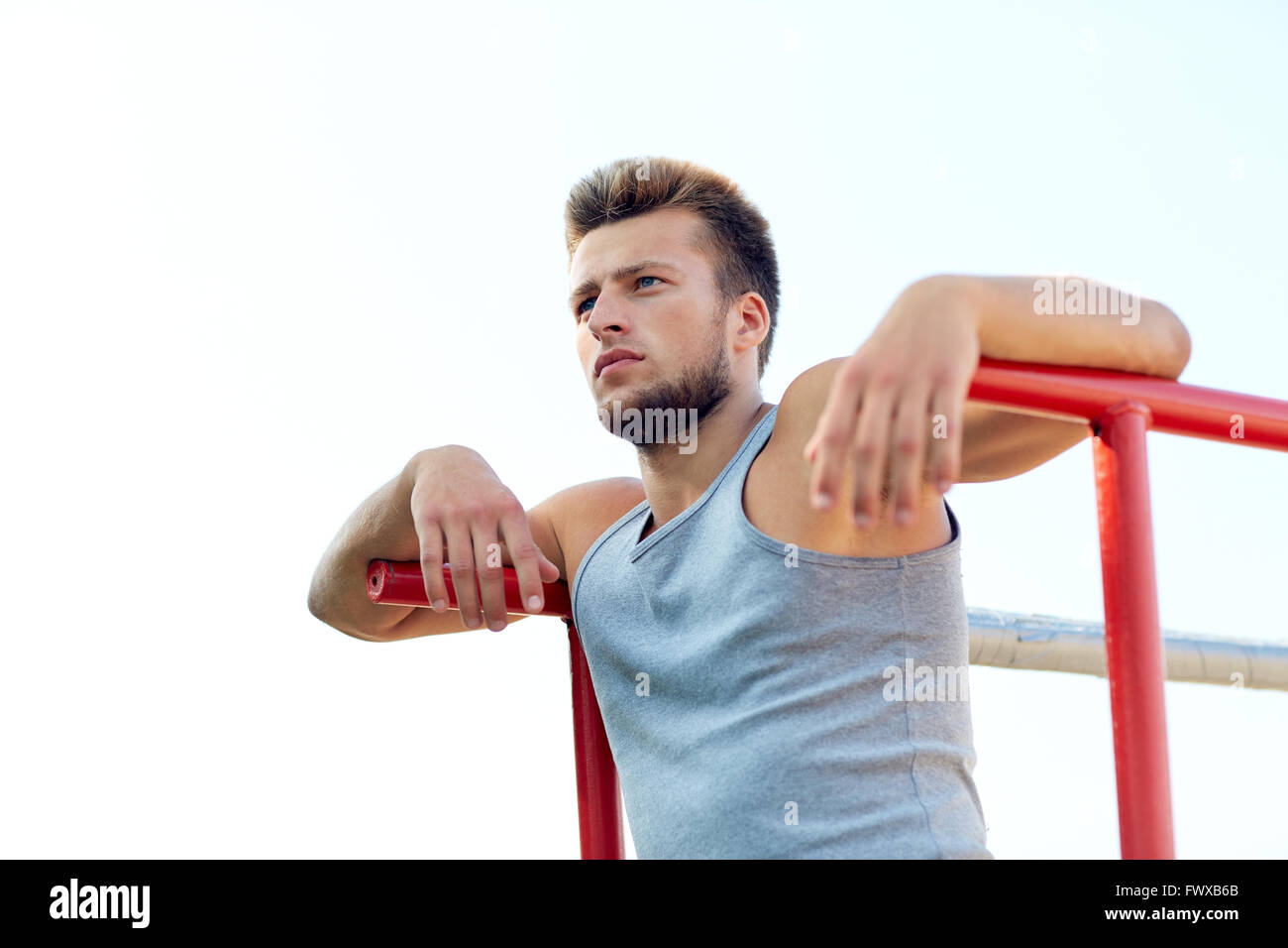 young man exercising on parallel bars outdoors Stock Photo - Alamy