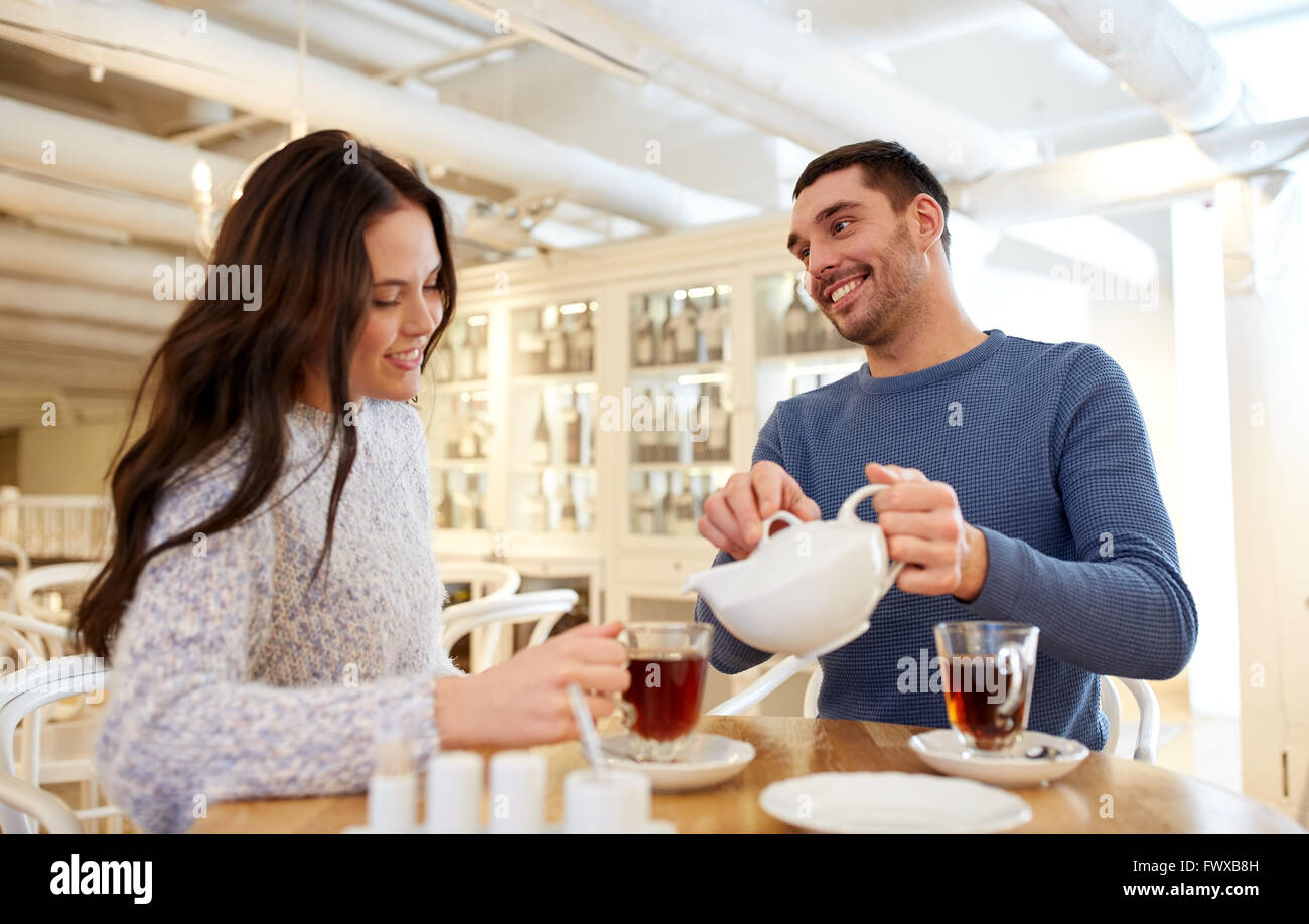 happy couple drinking tea at cafe Stock Photo - Alamy