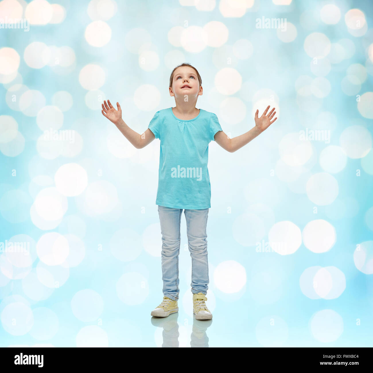 happy little girl looking up to something Stock Photo - Alamy