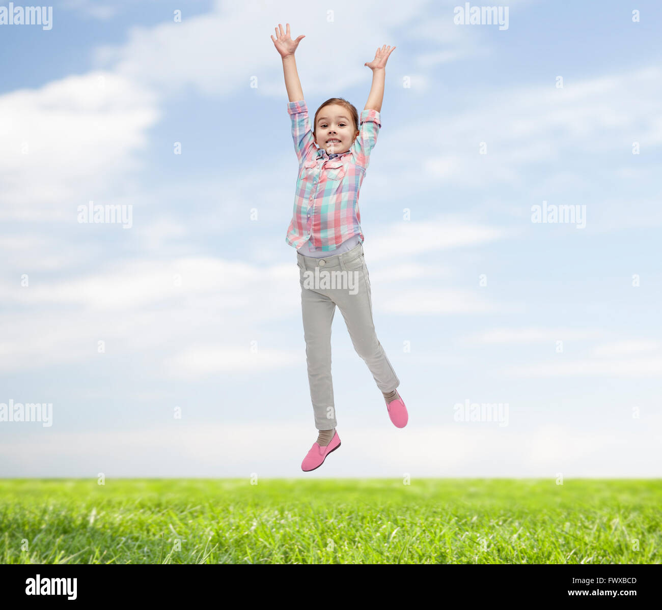 happy little girl jumping in air Stock Photo - Alamy