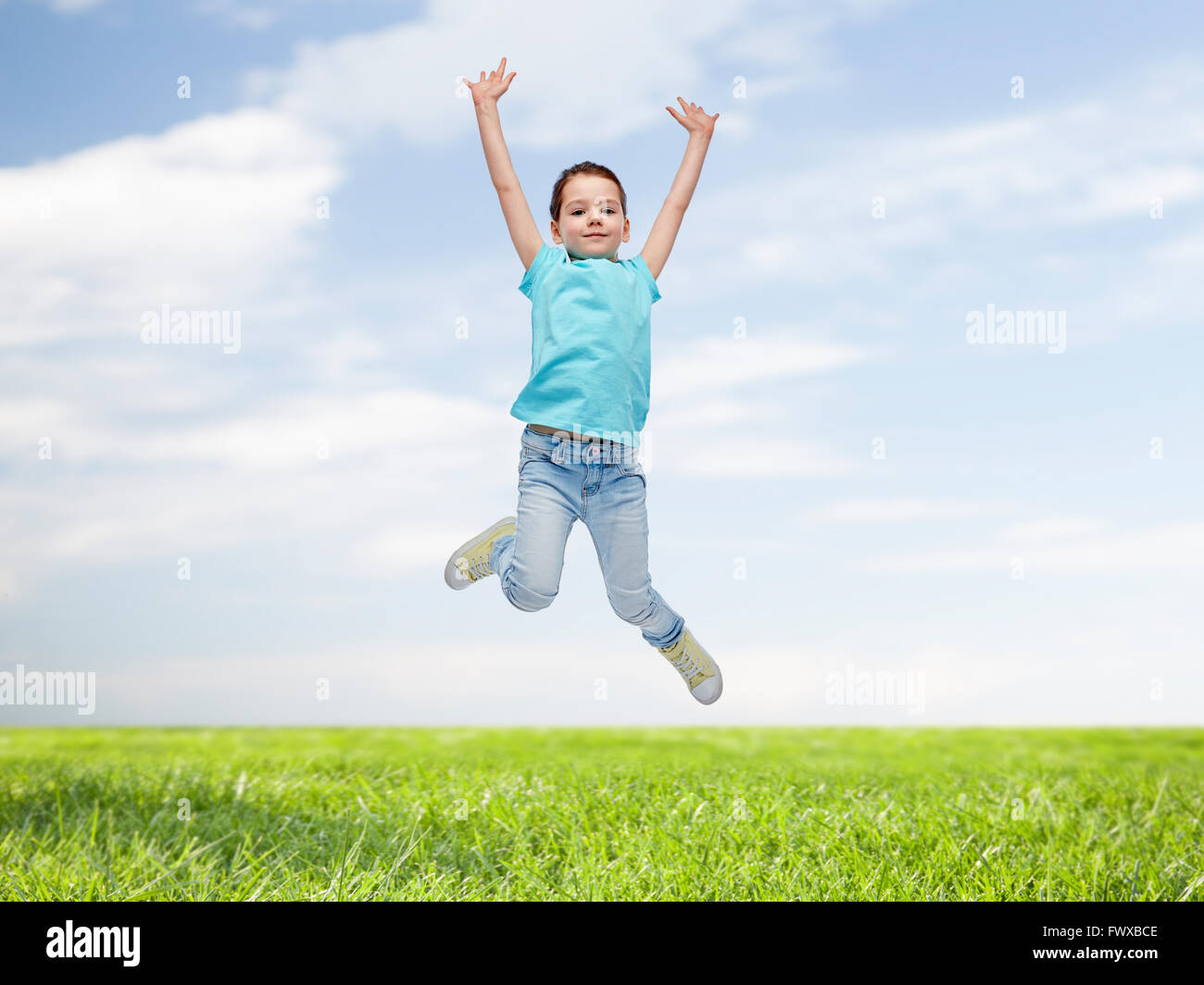 happy little girl jumping in air Stock Photo - Alamy