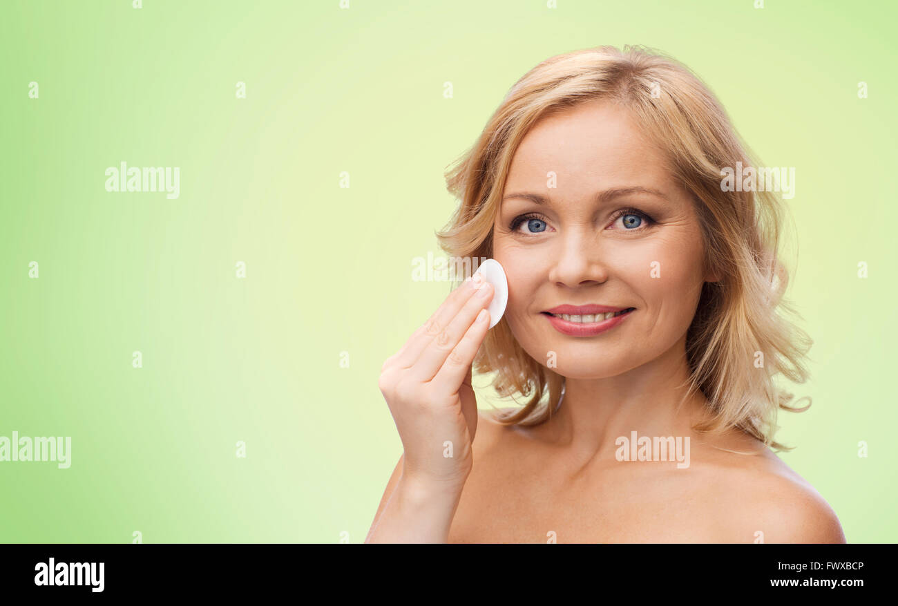happy woman cleaning face with cotton pad Stock Photo - Alamy