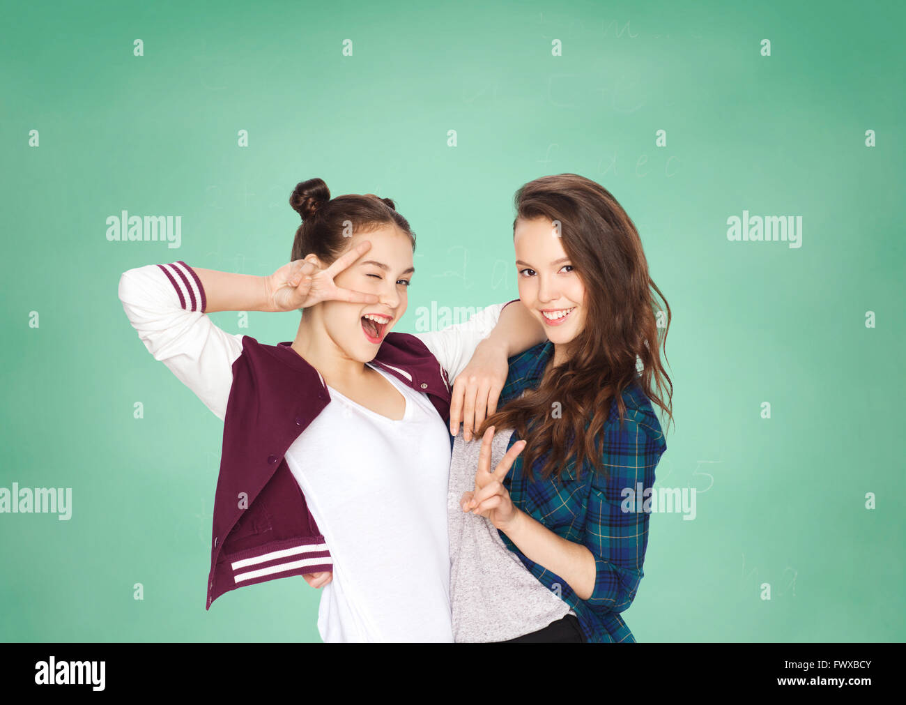 happy teenage student girls showing peace sign Stock Photo - Alamy