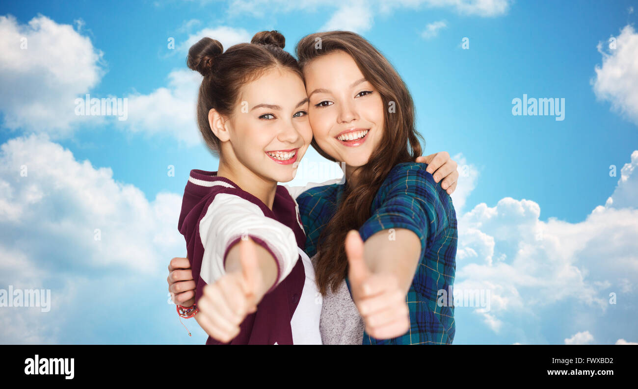 happy smiling teenage girls showing thumbs up Stock Photo - Alamy