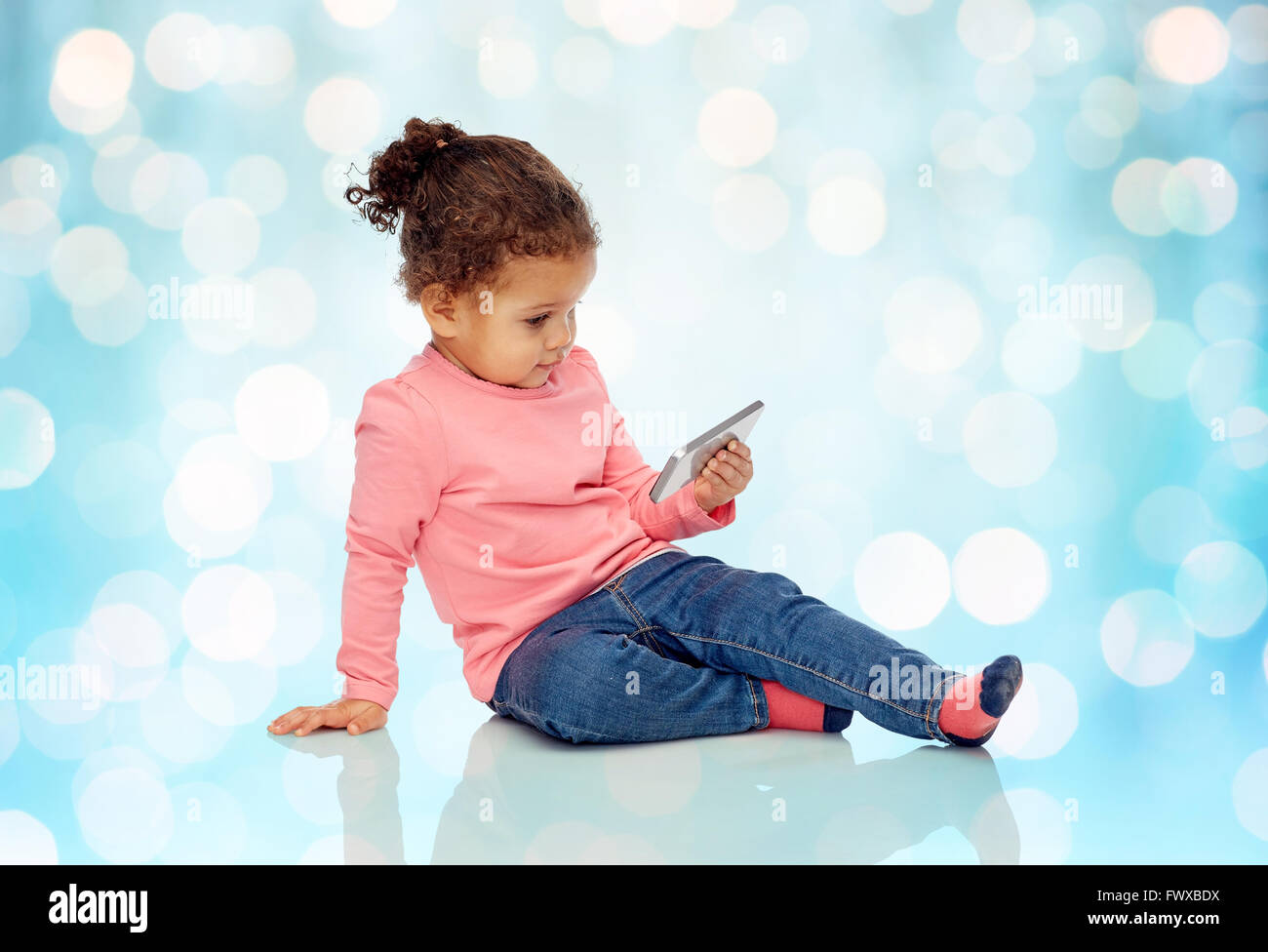 smiling little baby girl playing with smartphone Stock Photo - Alamy