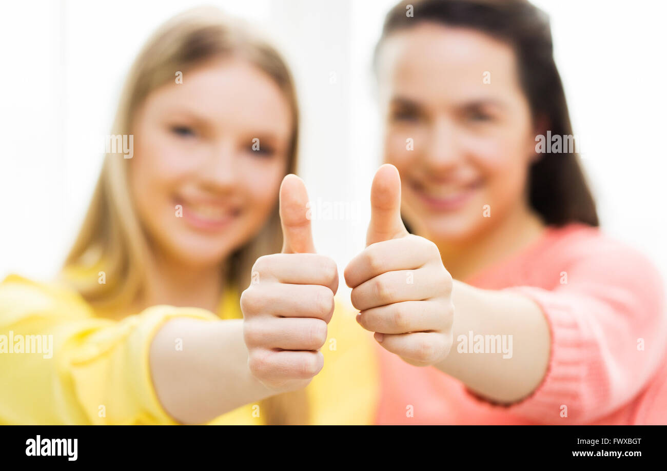happy teenage girls showing thumbs up Stock Photo - Alamy