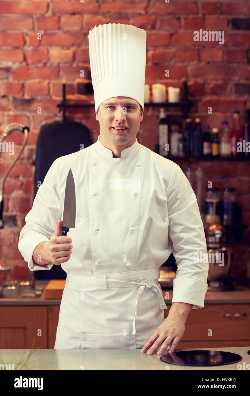 happy male chef cook in kitchen with knife Stock Photo - Alamy