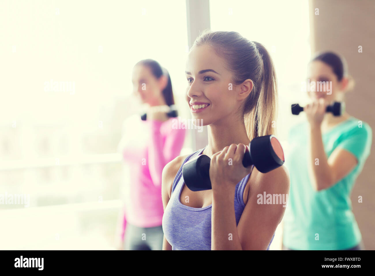 group of happy women with dumbbells in gym Stock Photo - Alamy
