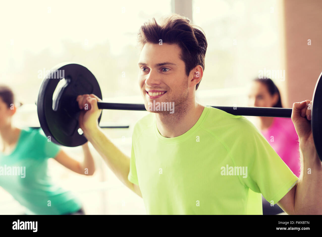 group of people exercising with barbell in gym Stock Photo - Alamy