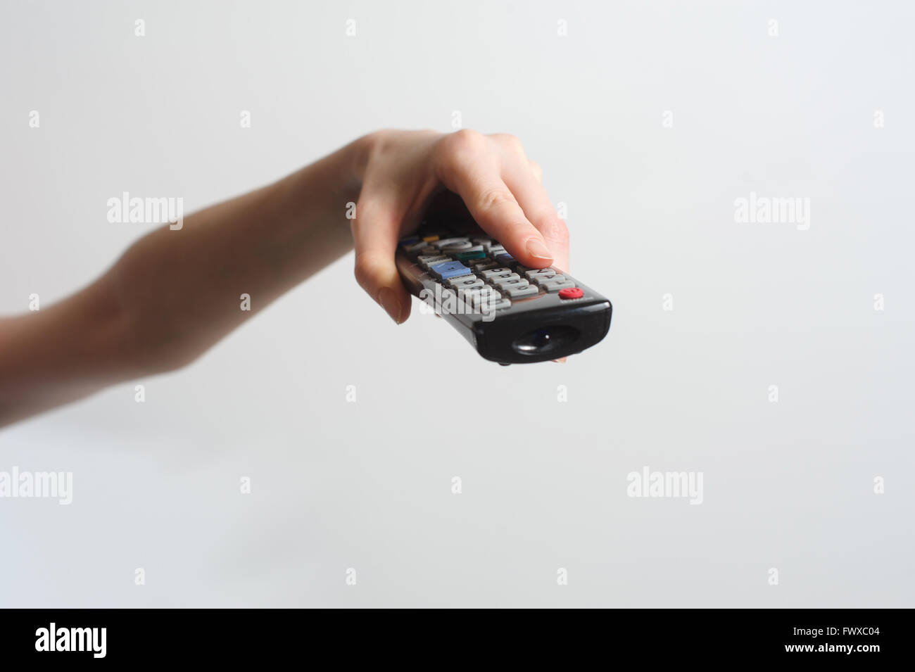 Girl with TV remote control Stock Photo - Alamy
