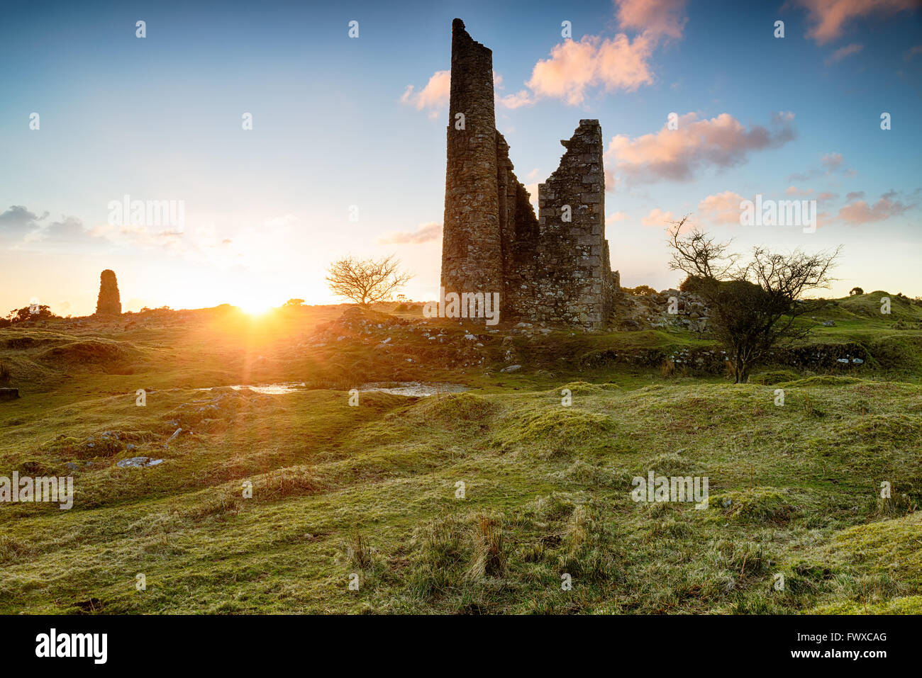 Sunset over the ruins of old tine mine engine houses on Bodmin Moor in ...