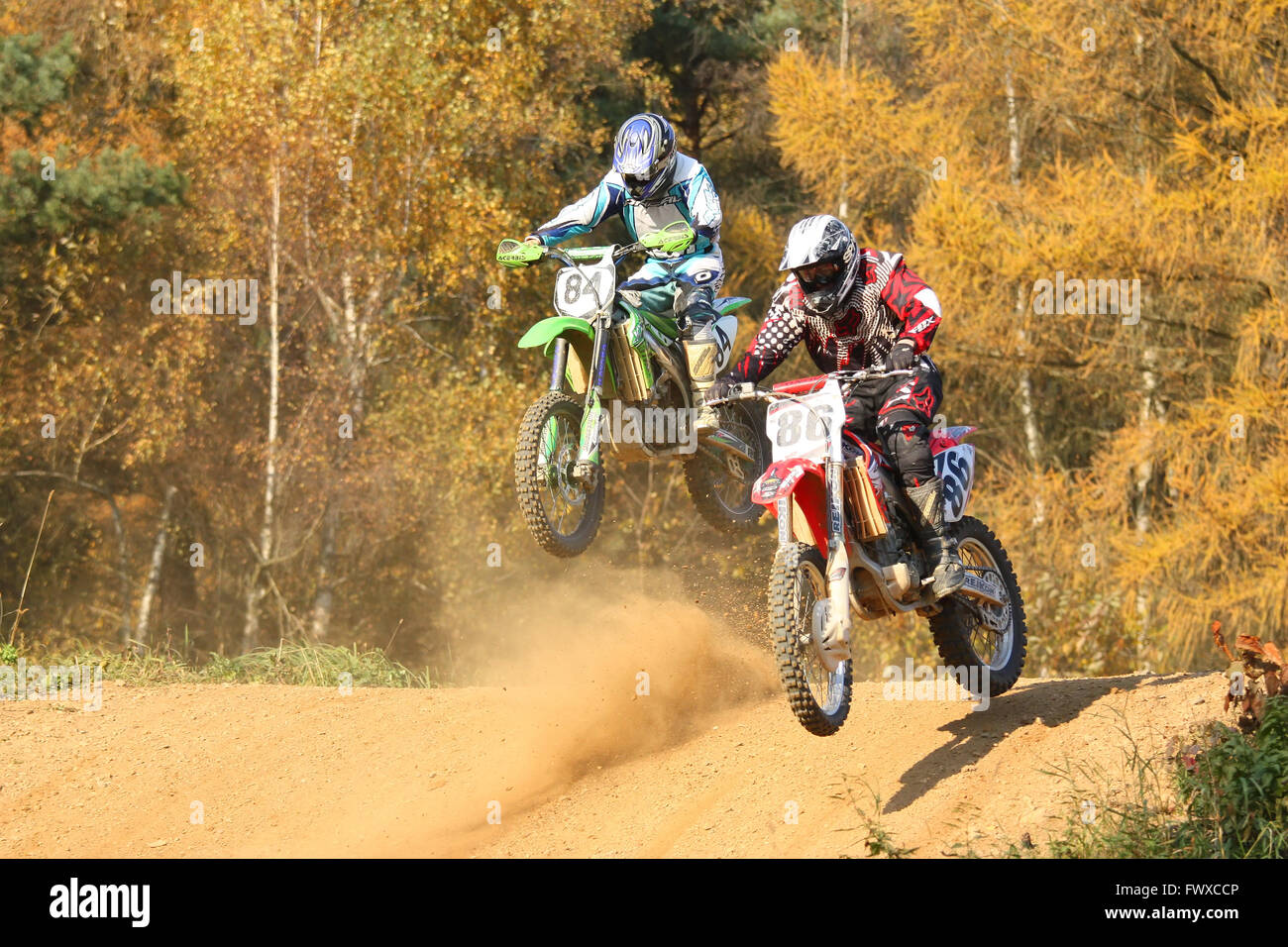 Two motocross racers are jumping in the race Stock Photo - Alamy