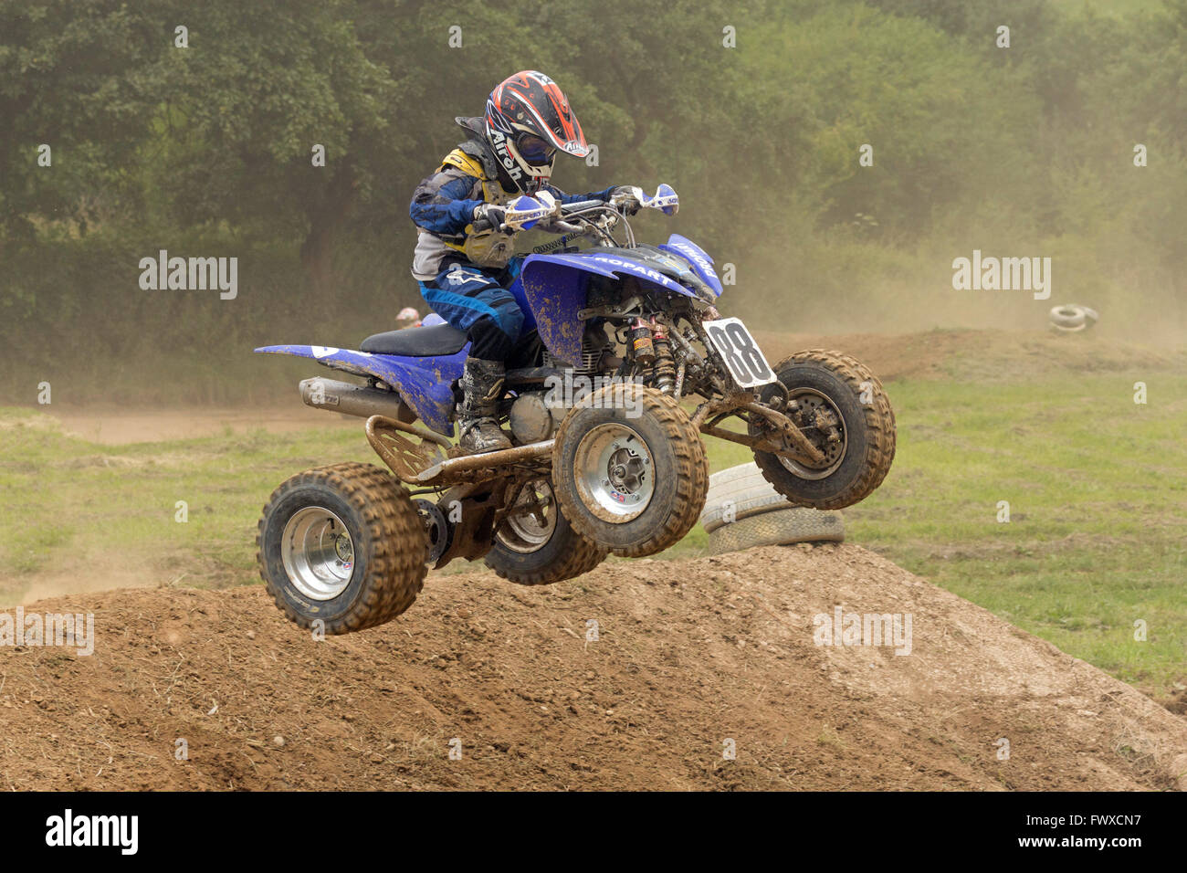 Young boy is jumping a quad in the quad race Stock Photo - Alamy