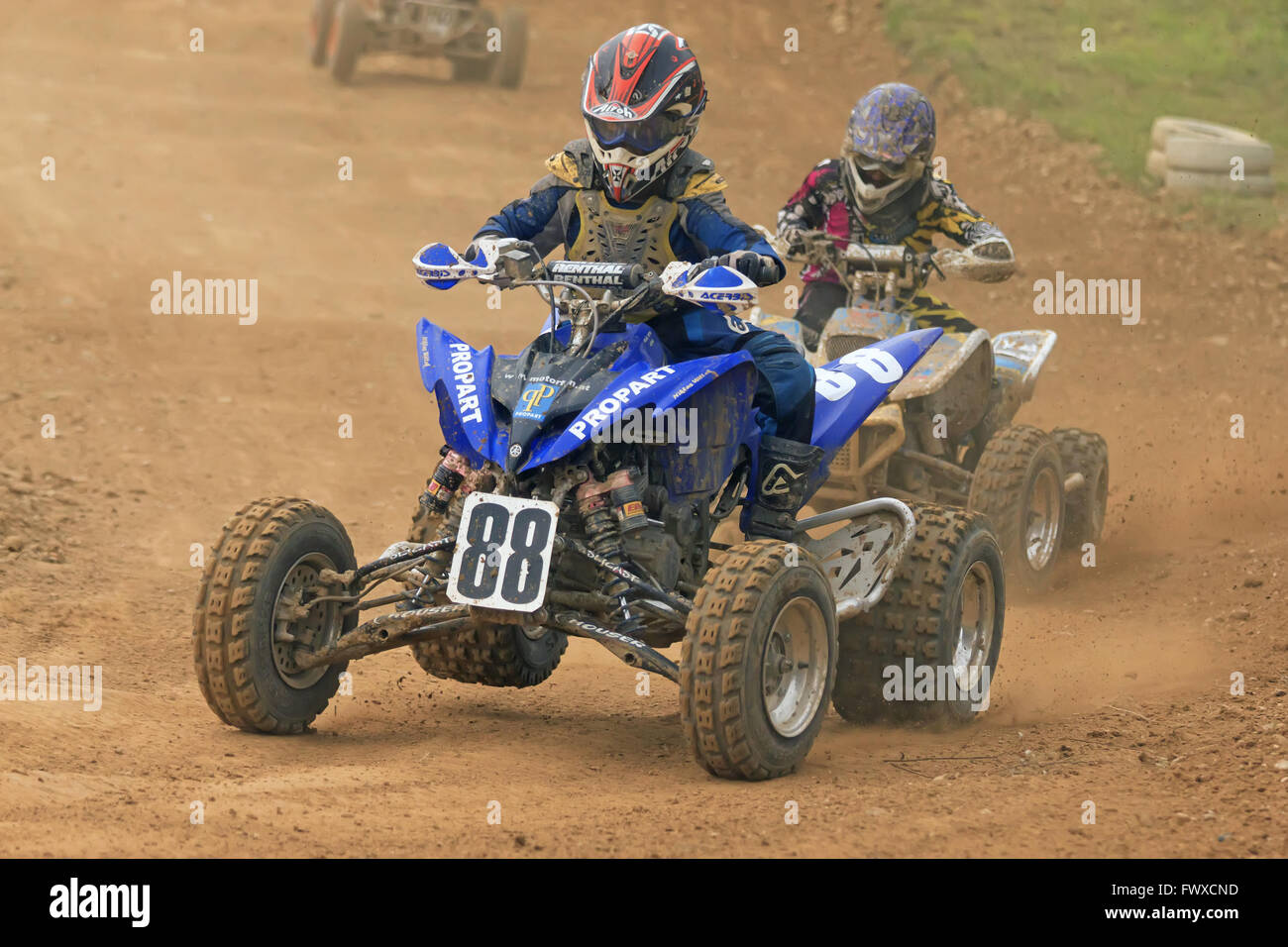 Young boy is riding a blue quad in the r Stock Photo - Alamy