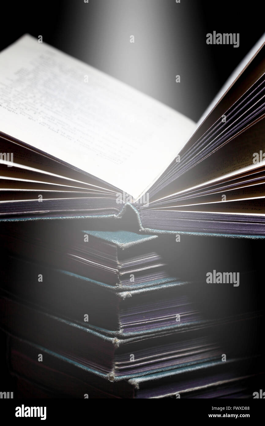 Books stacked light beam Stock Photo - Alamy