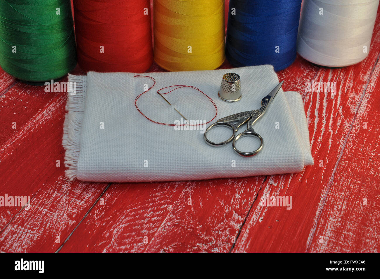 Thimble and thread spool on the old hi-res stock photography and images ...