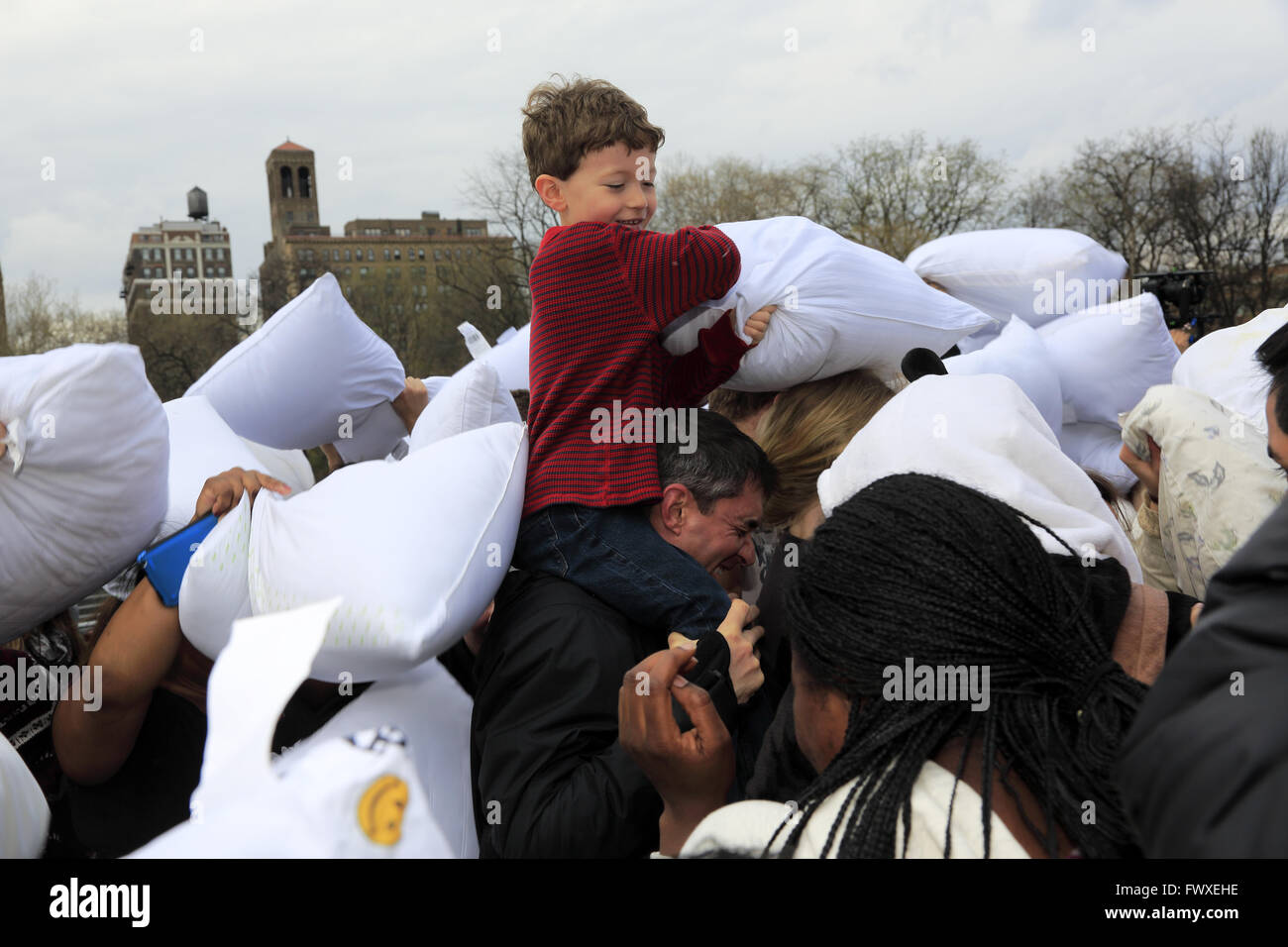 A young boy pillow fighting with others in International Pillow Fight ...