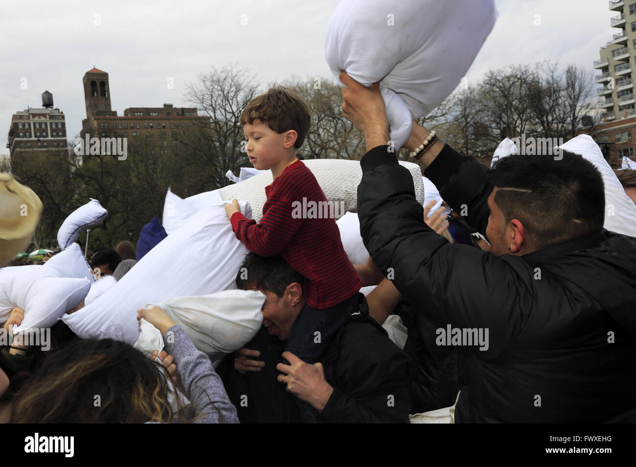 A young boy pillow fighting with others in International Pillow Fight ...