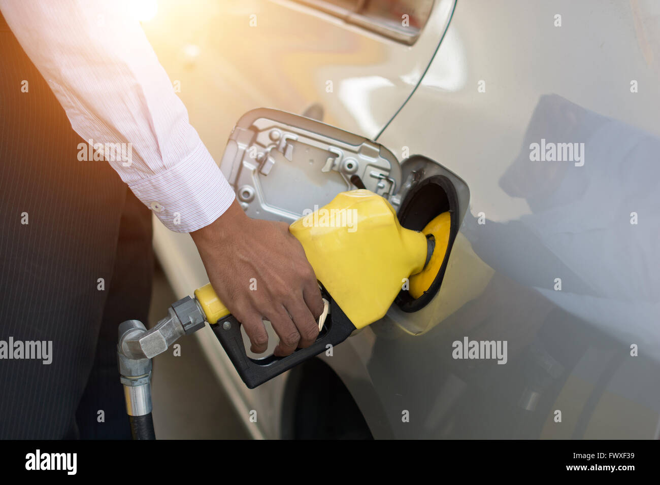 african male pumping gas at station Stock Photo - Alamy