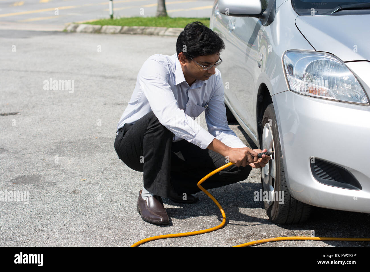 african male pumping air at station Stock Photo - Alamy