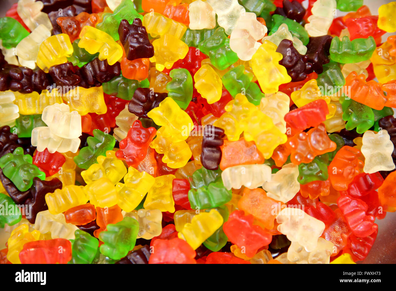 Group of sweet colorful gummy candies on street market as a background ...