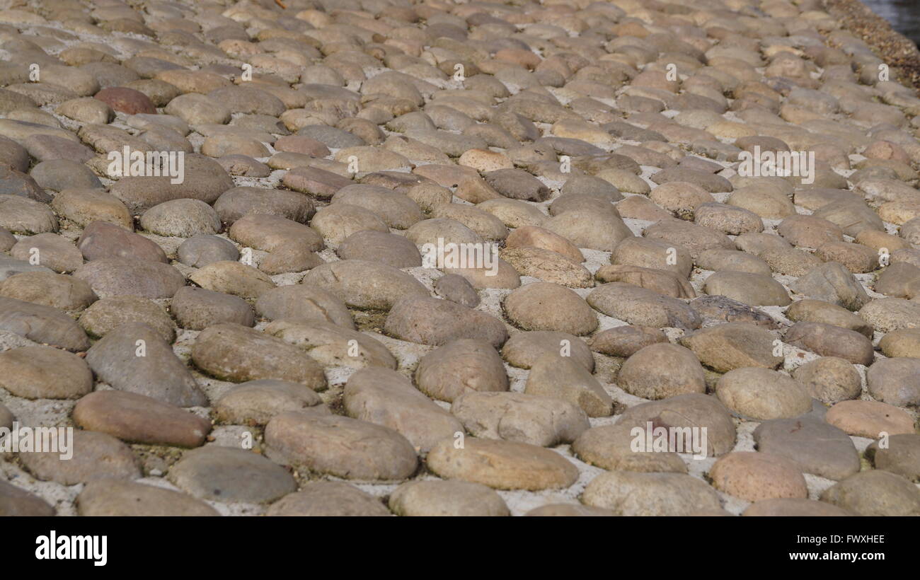 Pebbles lined up as abstract wallpaper Stock Photo - Alamy