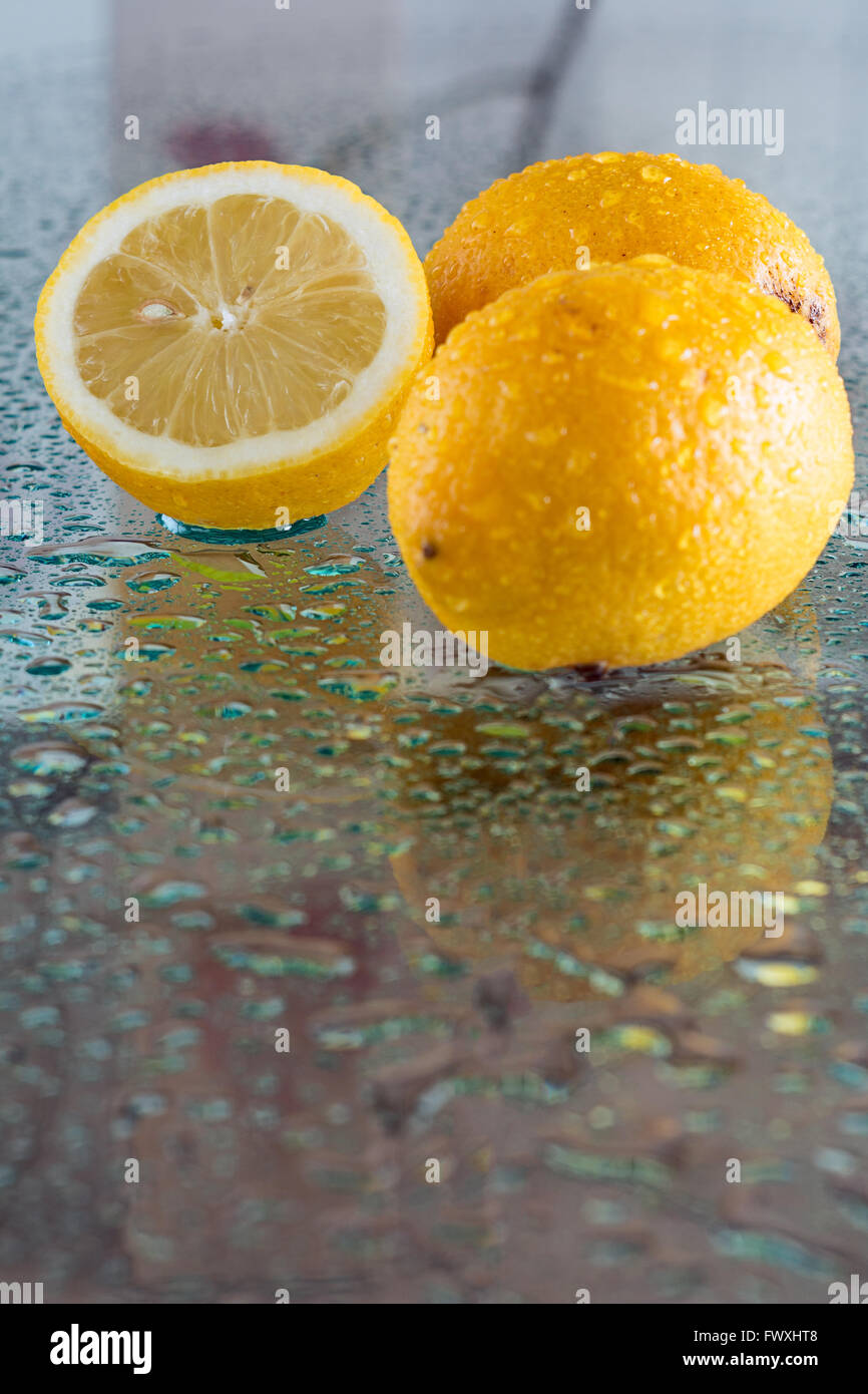 wet lemons on a glass surface Stock Photo - Alamy