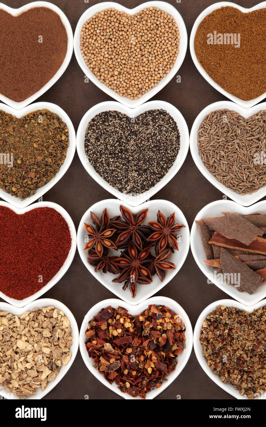 Spice selection in heart shaped porcelain dishes Stock Photo - Alamy