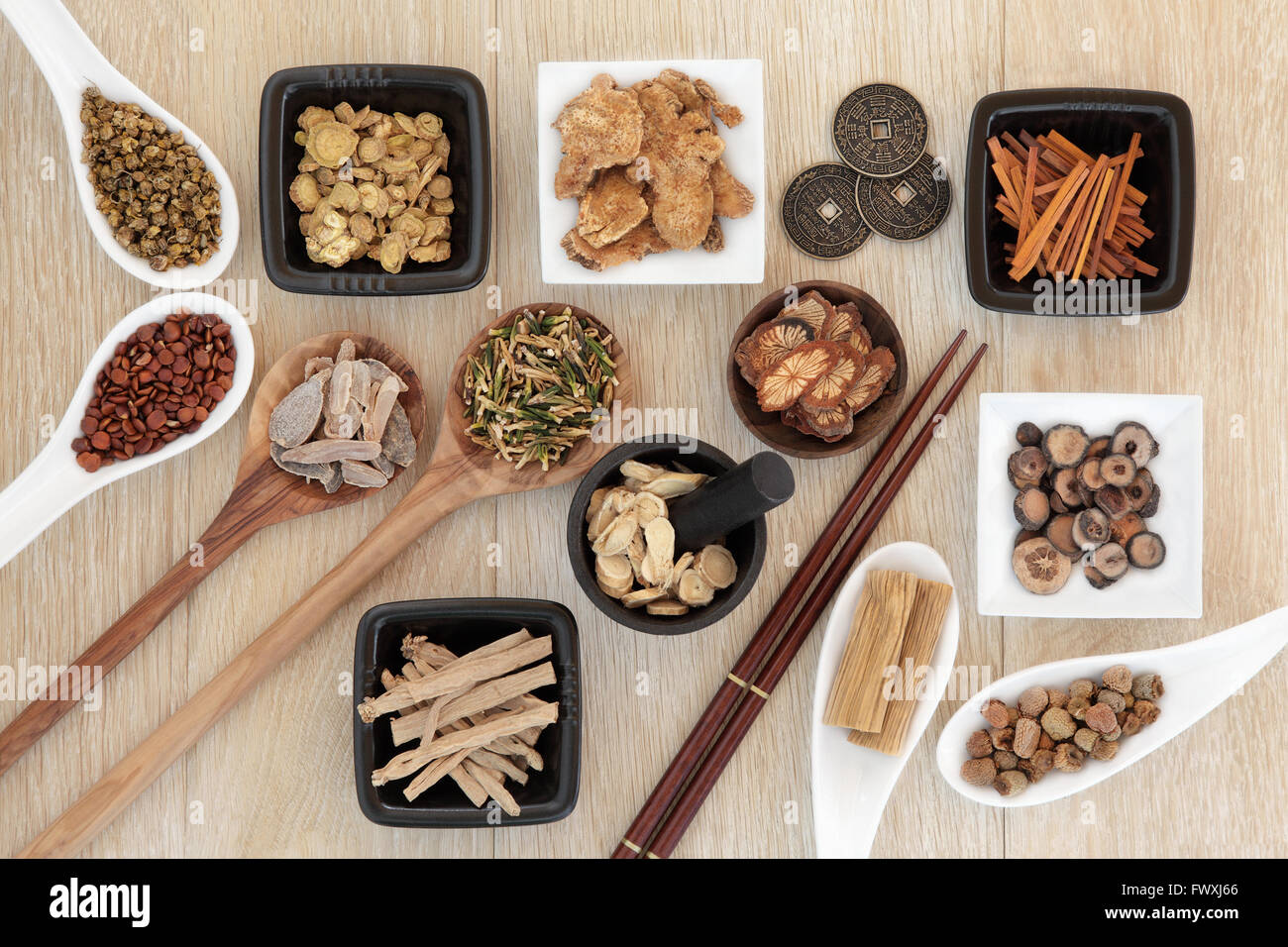 Chinese herbal medicine selection with I ching coins, mortar with ...