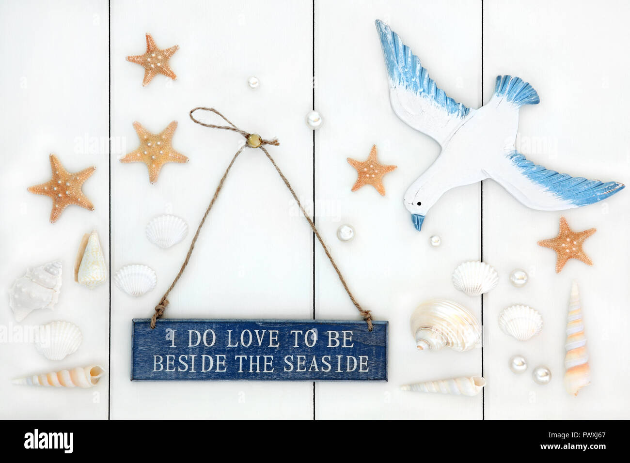 Seaside sign with starfish and seashells and decorative seagull on ...
