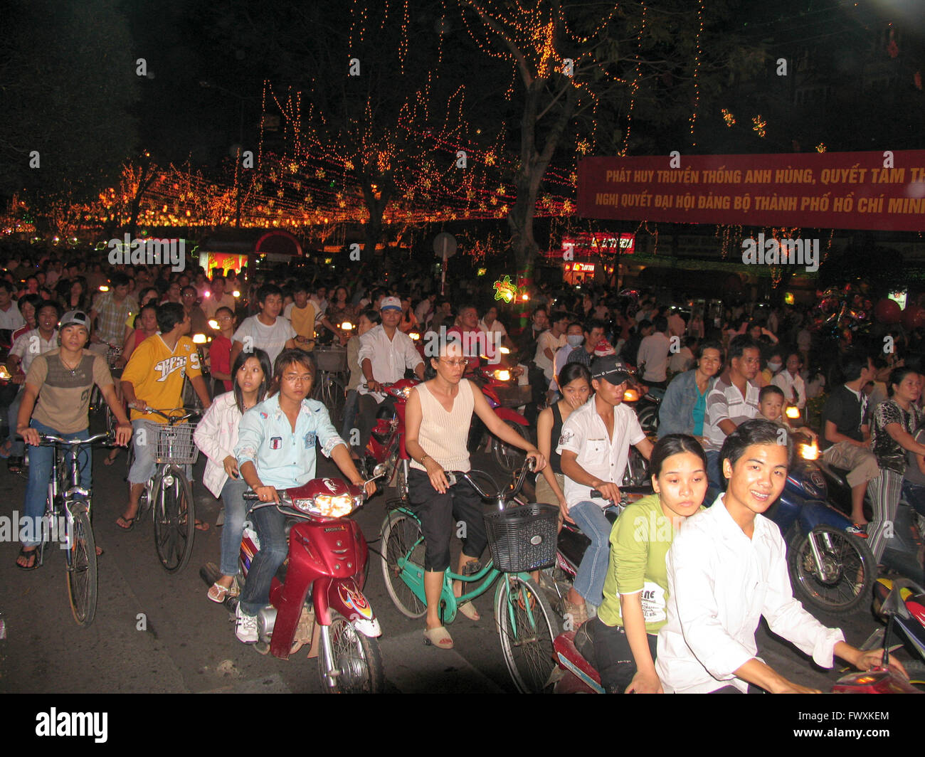 Dense traffic of bicycles, scooters and motorbikes at night Stock Photo ...