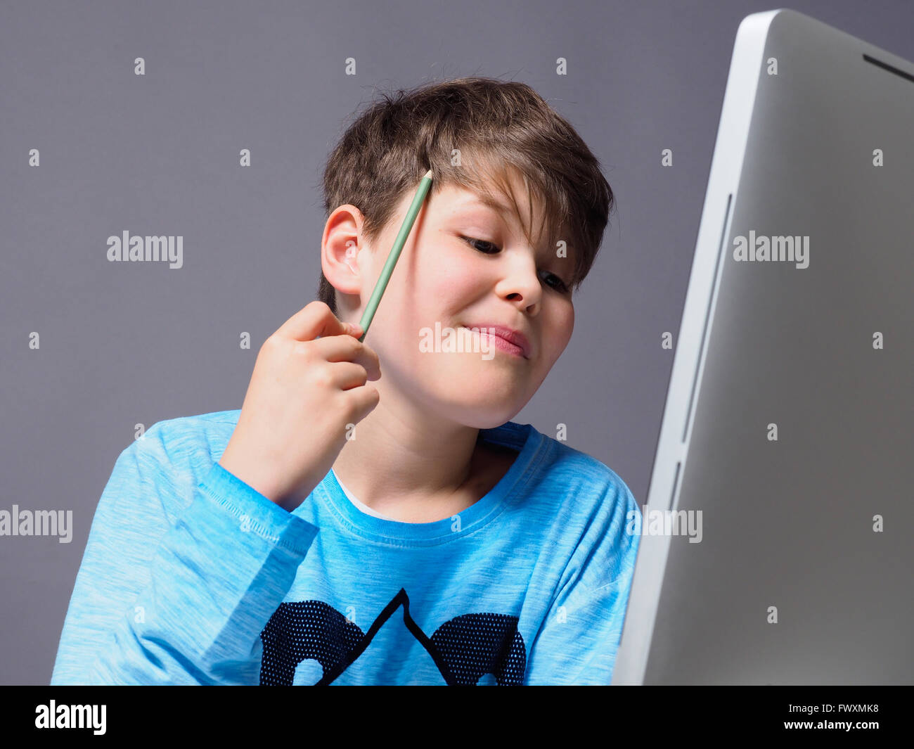 Teenage boy learning on a computer at home Stock Photo - Alamy