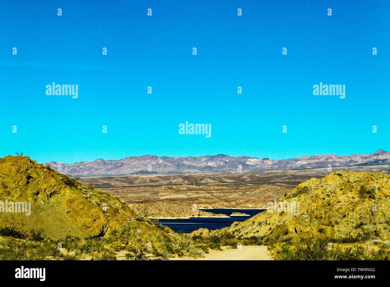 A road in the Nevada desert leading to Lake Mohave and Davis Dam on a ...
